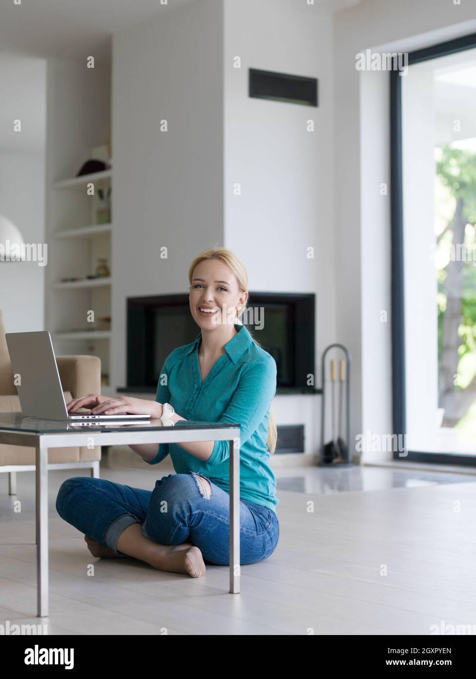 beautiful young women using laptop computer on the floor of her luxury ...