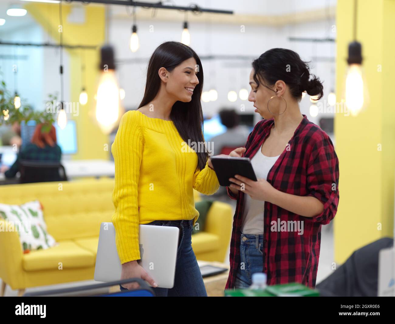 group of female friends having a team meeting and discussion about ...