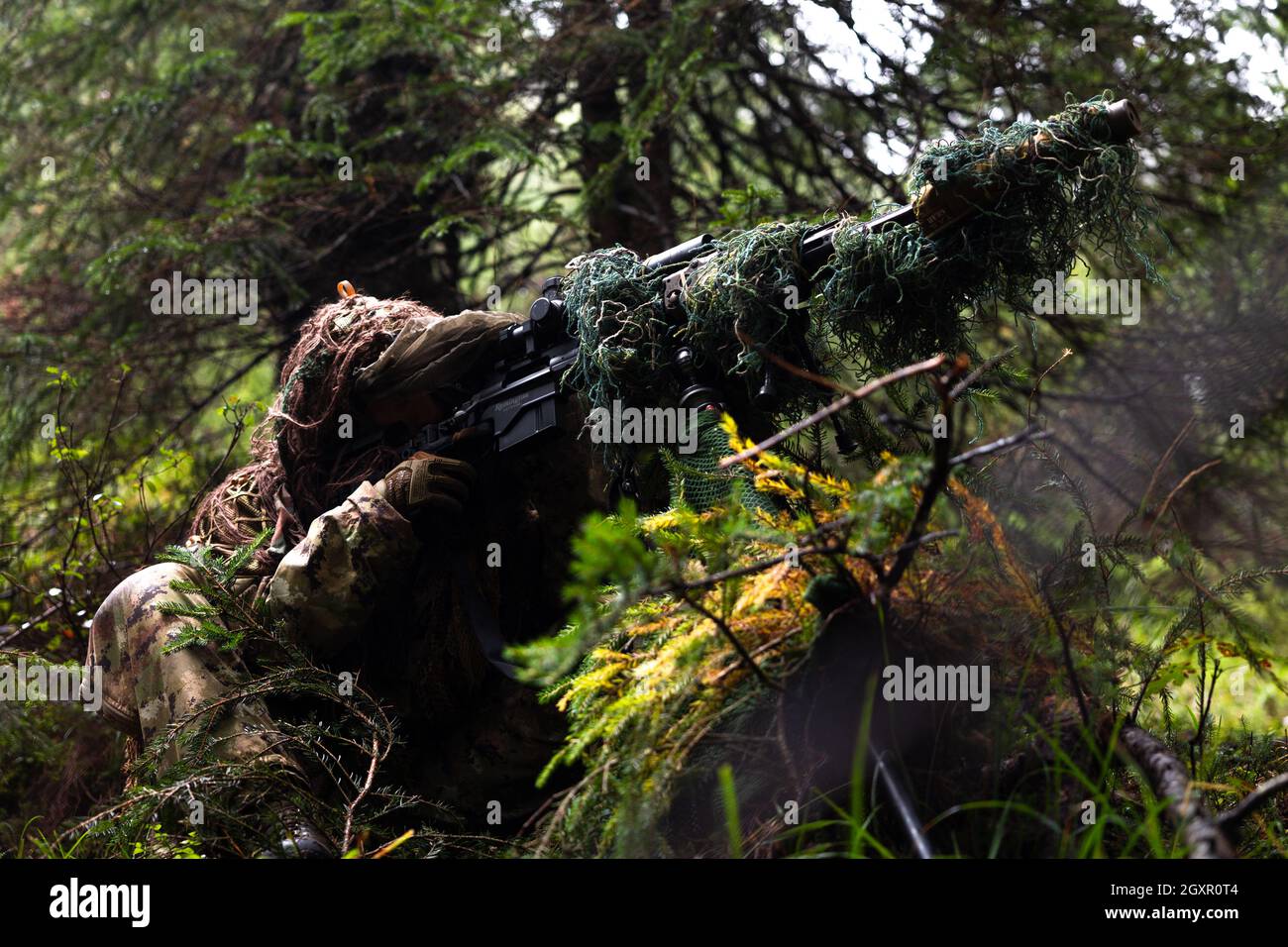 An Italian Special Forces Sniper waits for his target to appear during ...