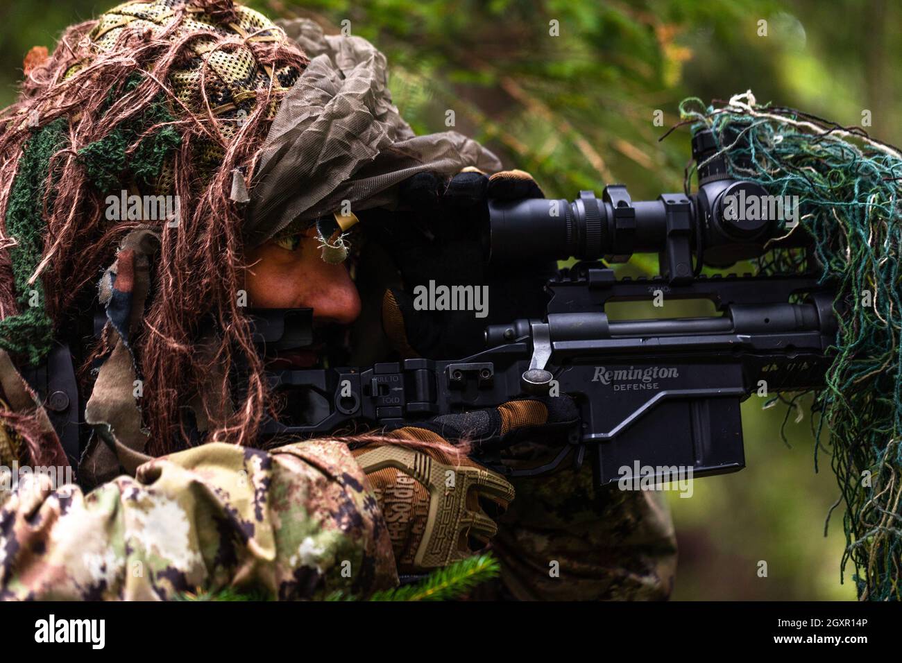 An Italian Special Forces Sniper looks downrage at his target during a ...