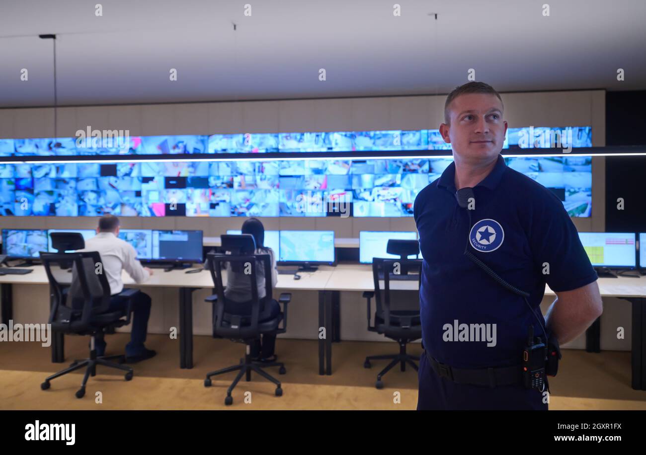 portrait of young male security operator working in a data system ...