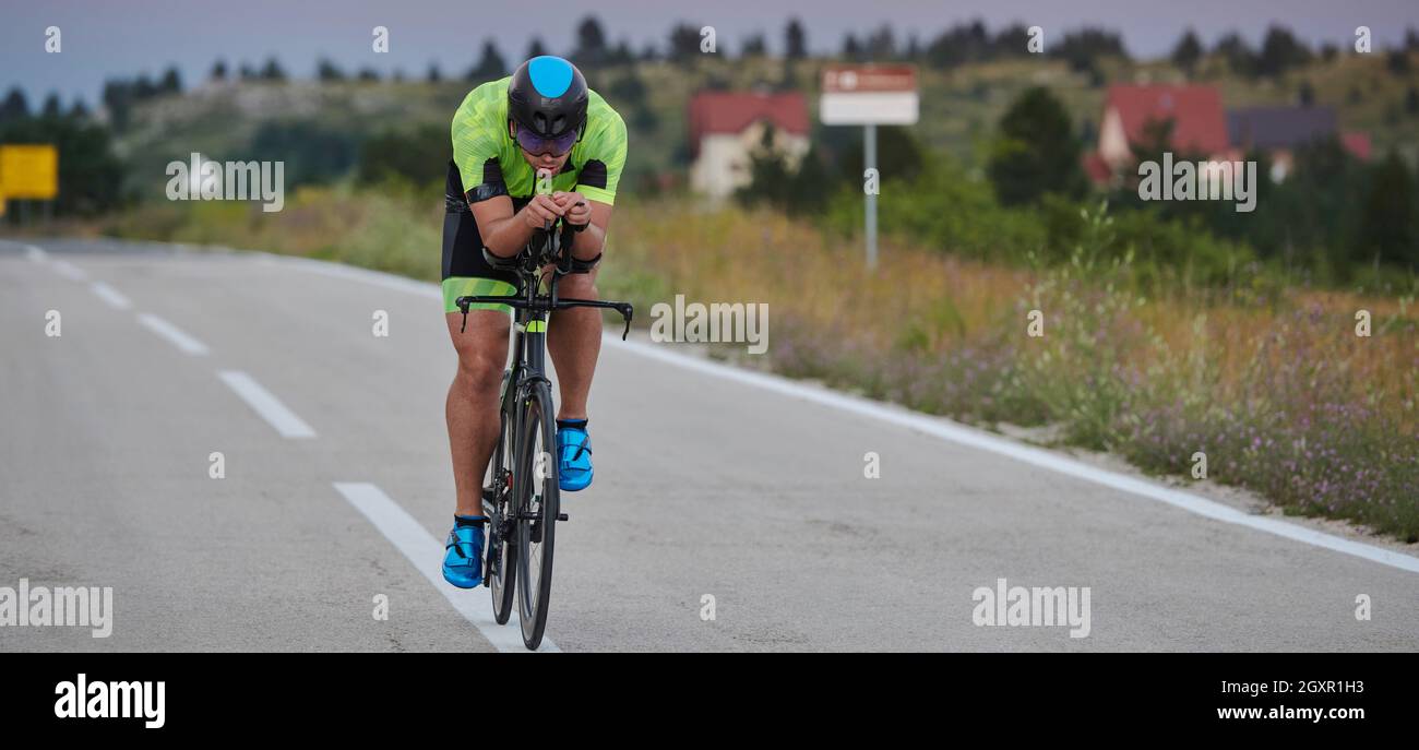 triathlon athlete riding professional racing bike at workout on curvy country road Stock Photo ...
