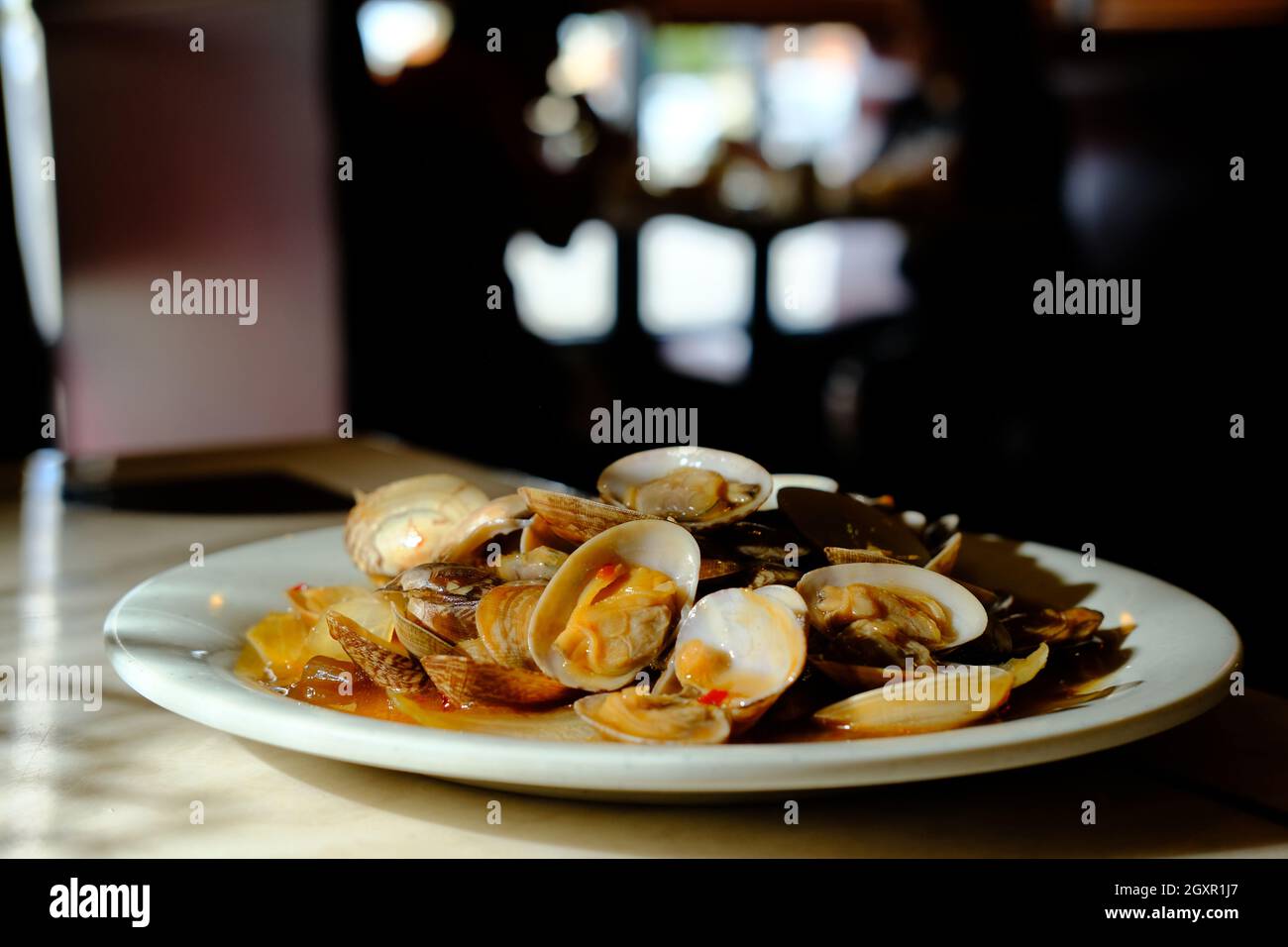 Chinese baby clams on the shell with black bean sauce Stock Photo - Alamy