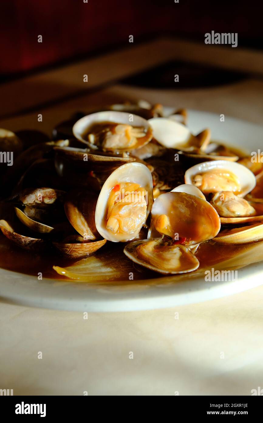 Chinese baby clams on the shell with black bean sauce Stock Photo - Alamy
