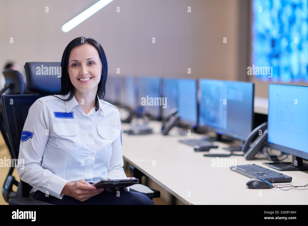 Portrait Of Female Security Operator While Working In A Data System Control Room Offices