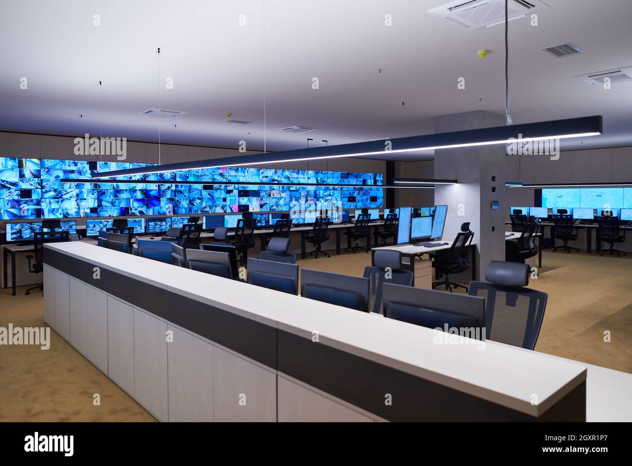 Empty interior of big modern security system control room, workstation ...