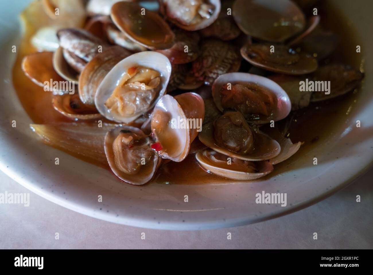 Chinese baby clams on the shell with black bean sauce Stock Photo - Alamy