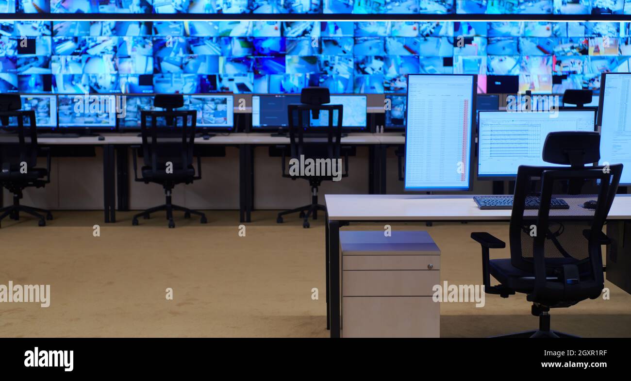 Empty interior of big modern security system control room, workstation ...