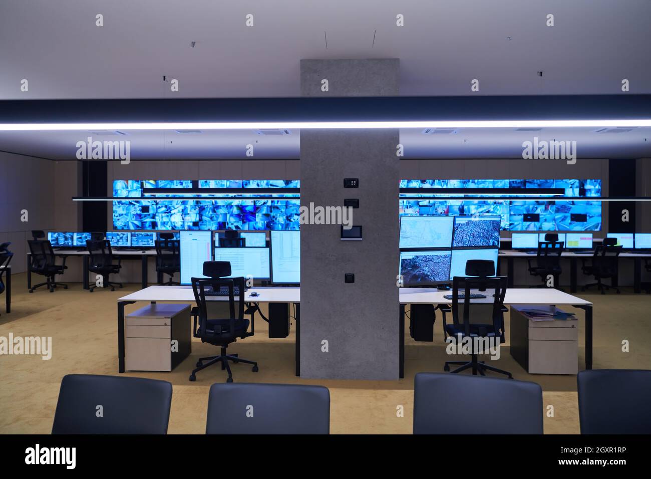 Empty interior of big modern security system control room, workstation ...