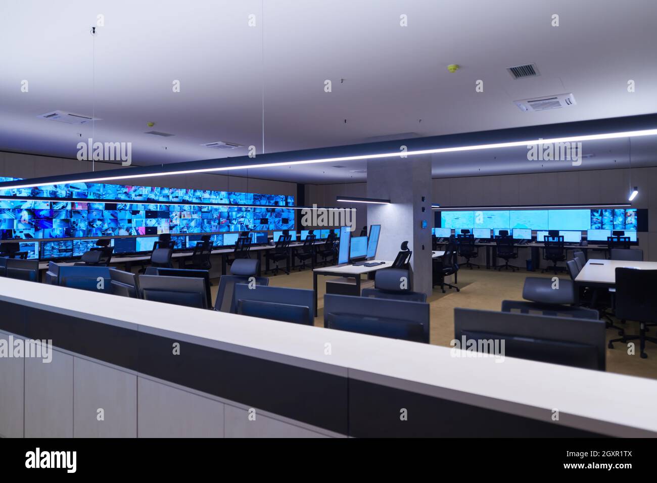 Empty interior of big modern security system control room, workstation ...