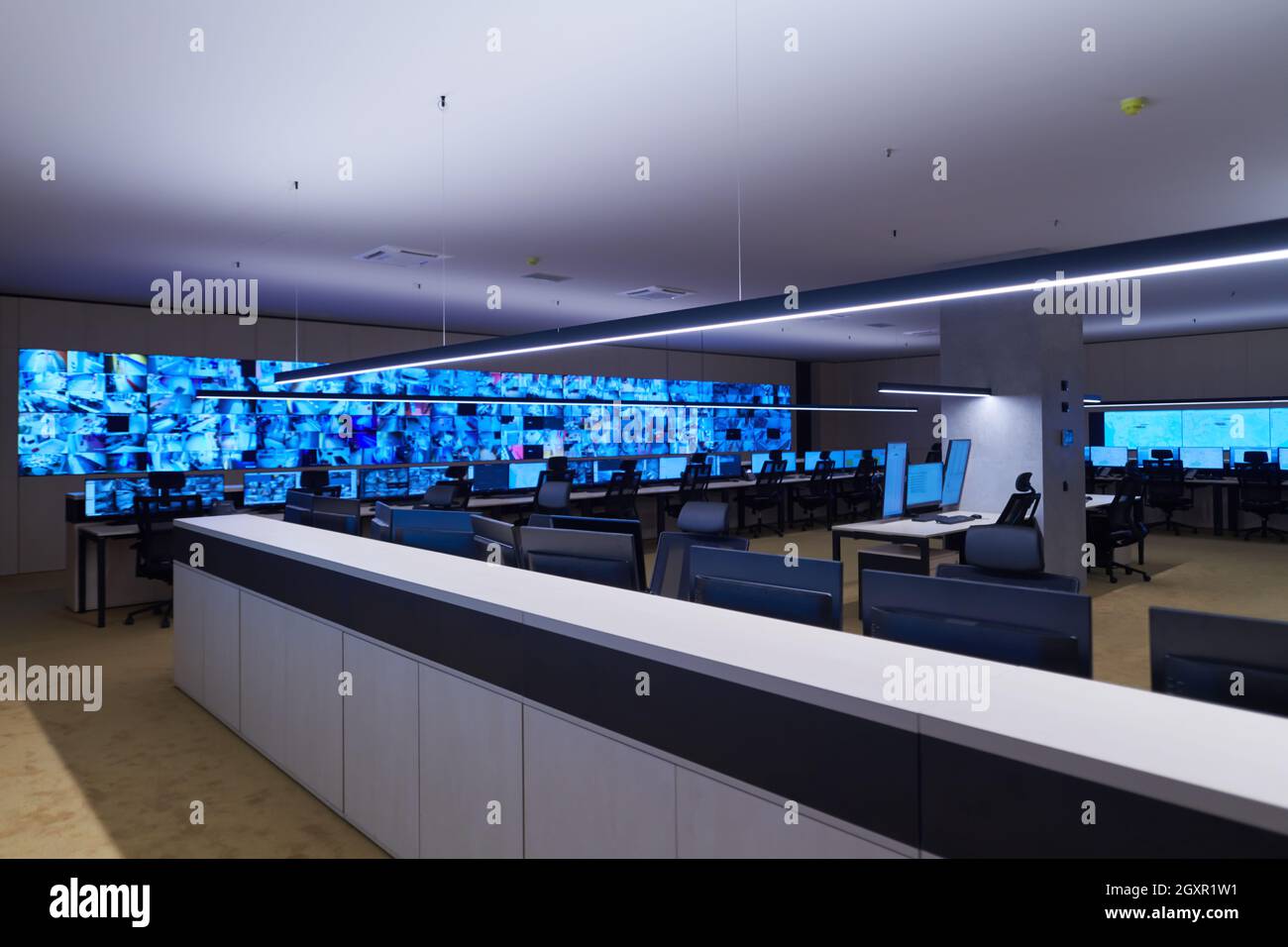Empty interior of big modern security system control room, workstation ...