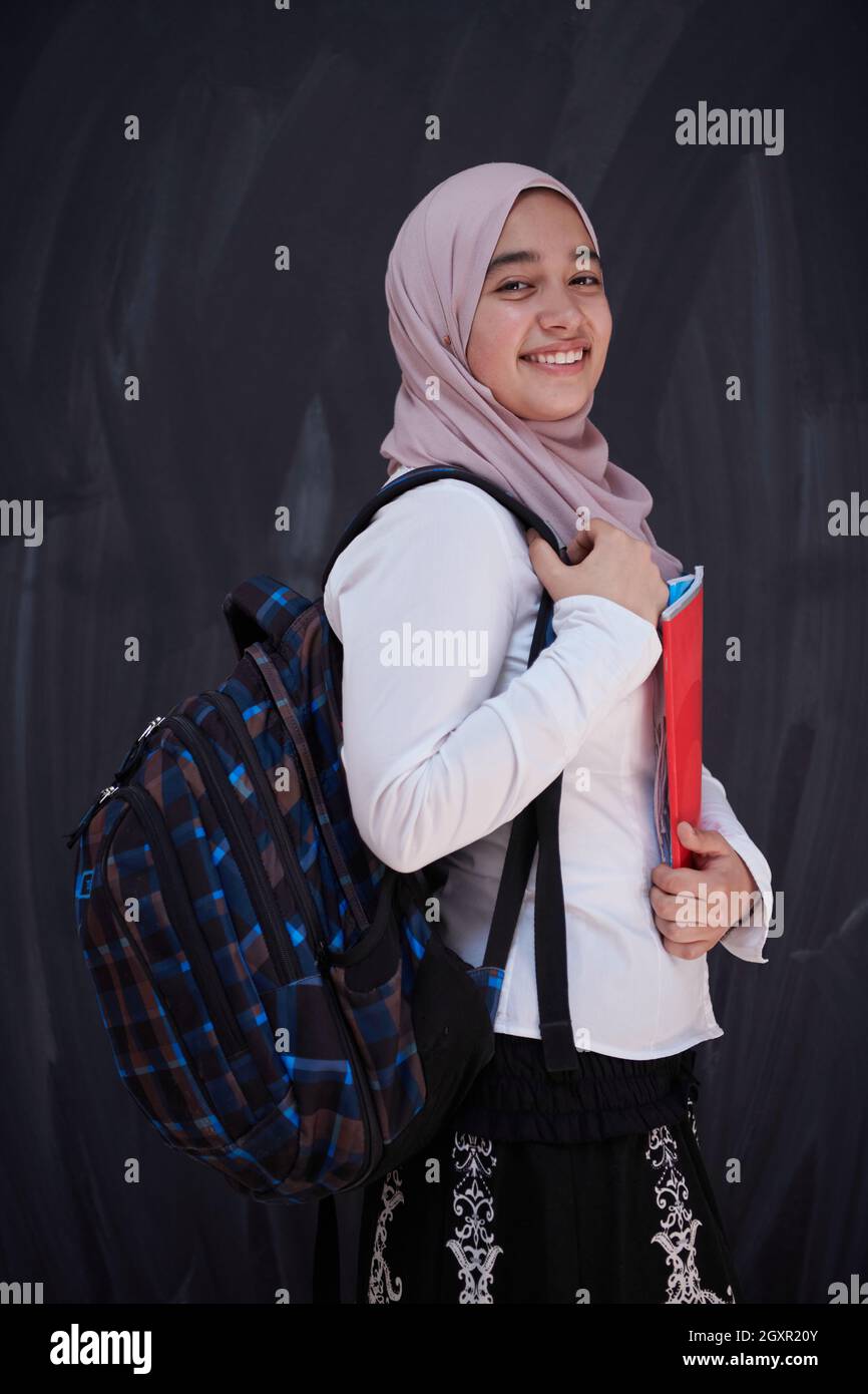 portrait of happy female middle eastern university student against ...