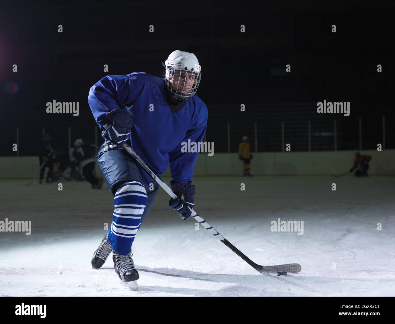 ice hockey player in action kicking with stick Stock Photo - Alamy