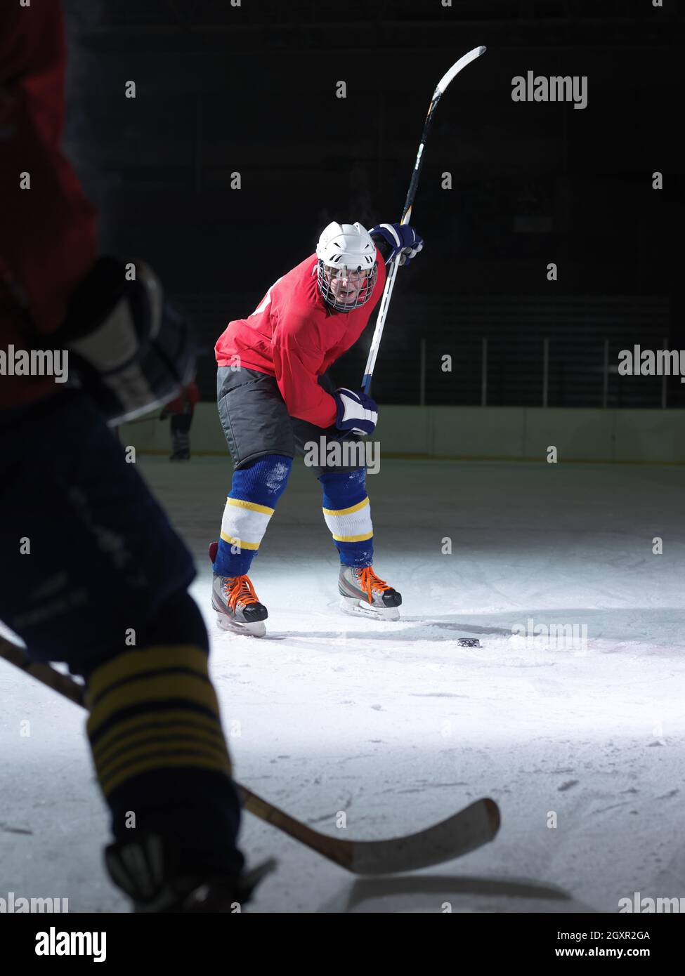 ice hockey player in action kicking with stick Stock Photo - Alamy