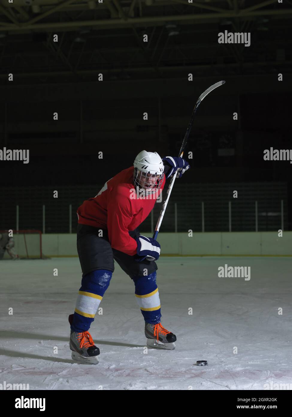 ice hockey player in action kicking with stick Stock Photo - Alamy