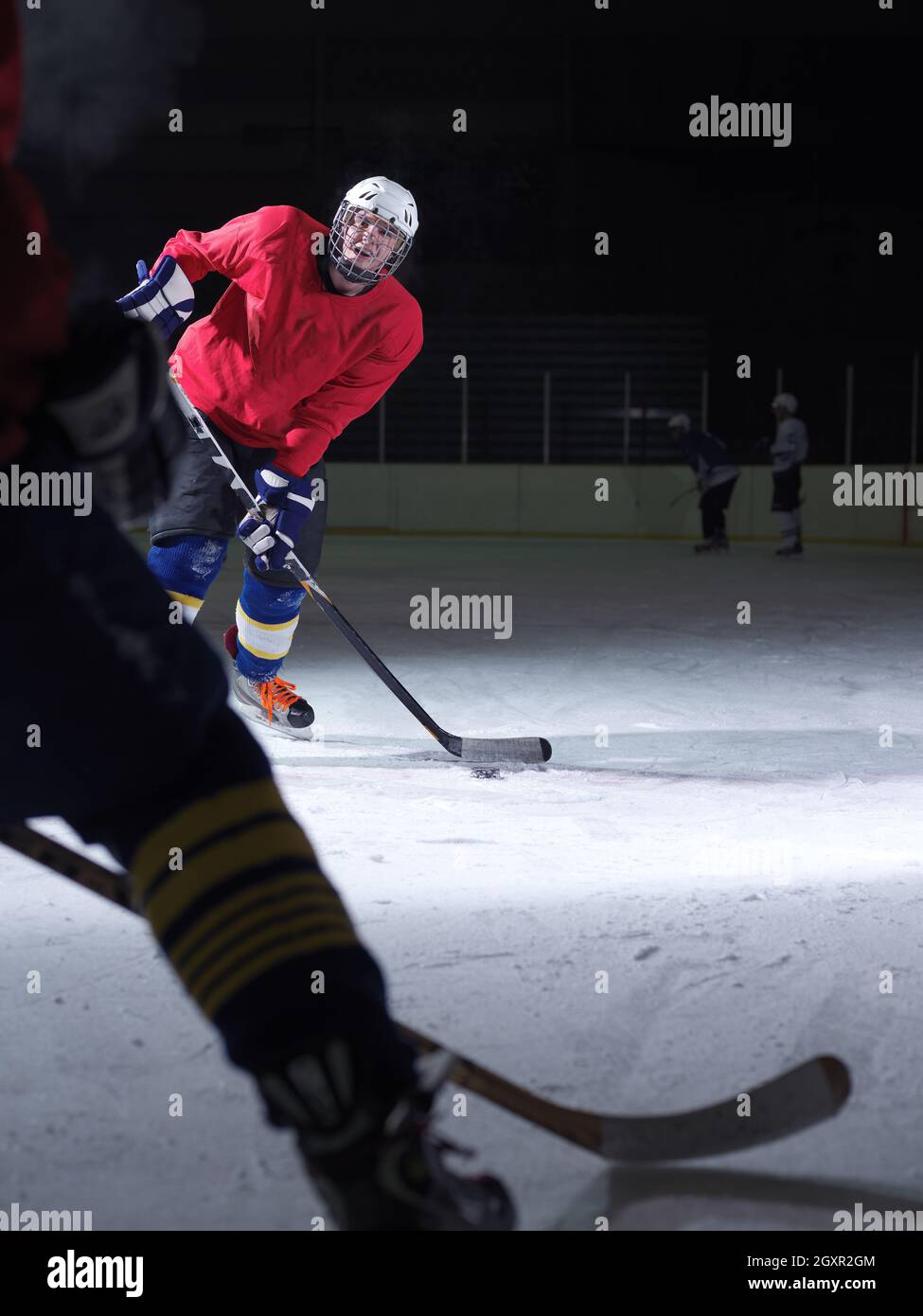 ice hockey player in action kicking with stick Stock Photo - Alamy