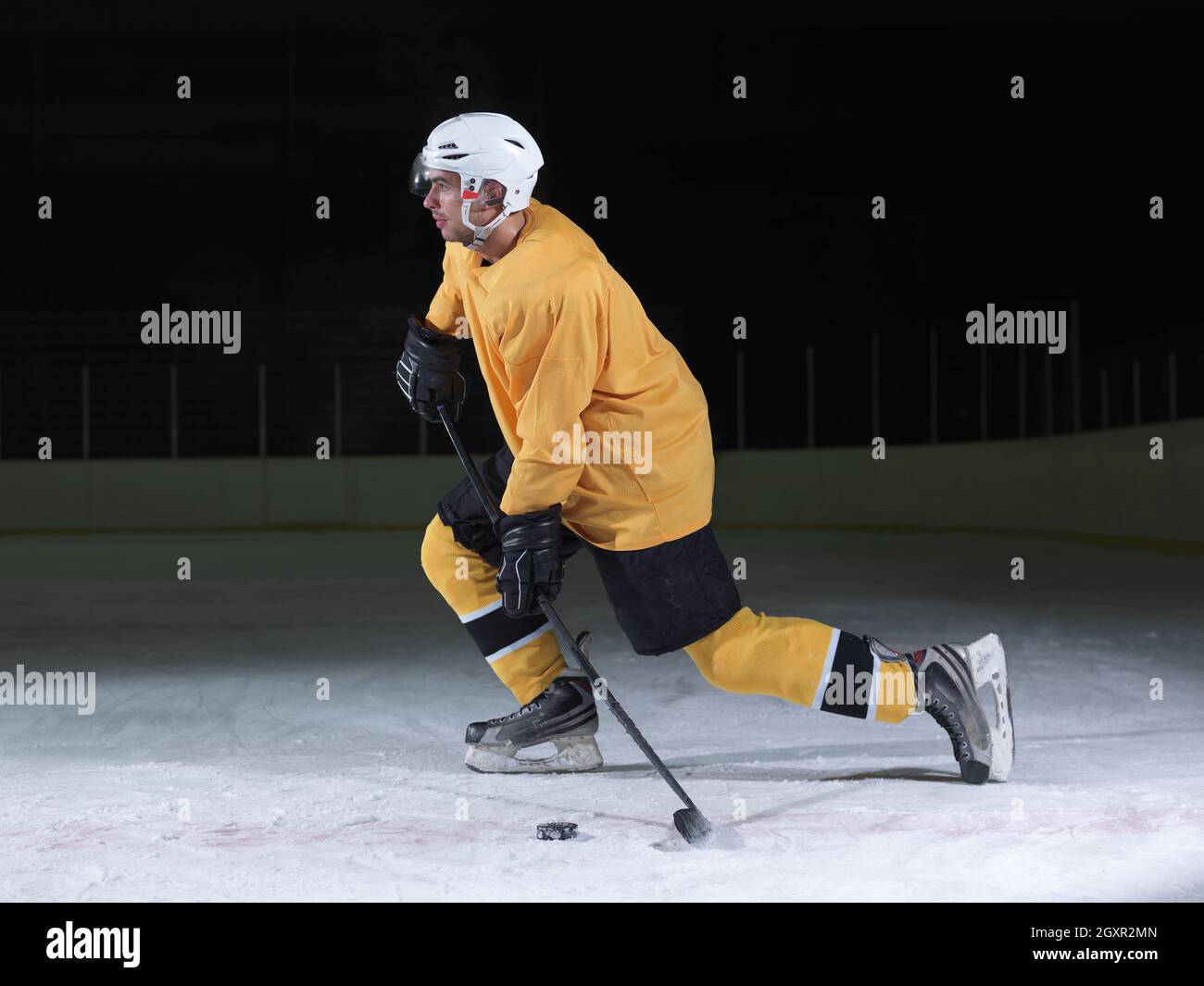 ice hockey player in action kicking with stick Stock Photo - Alamy