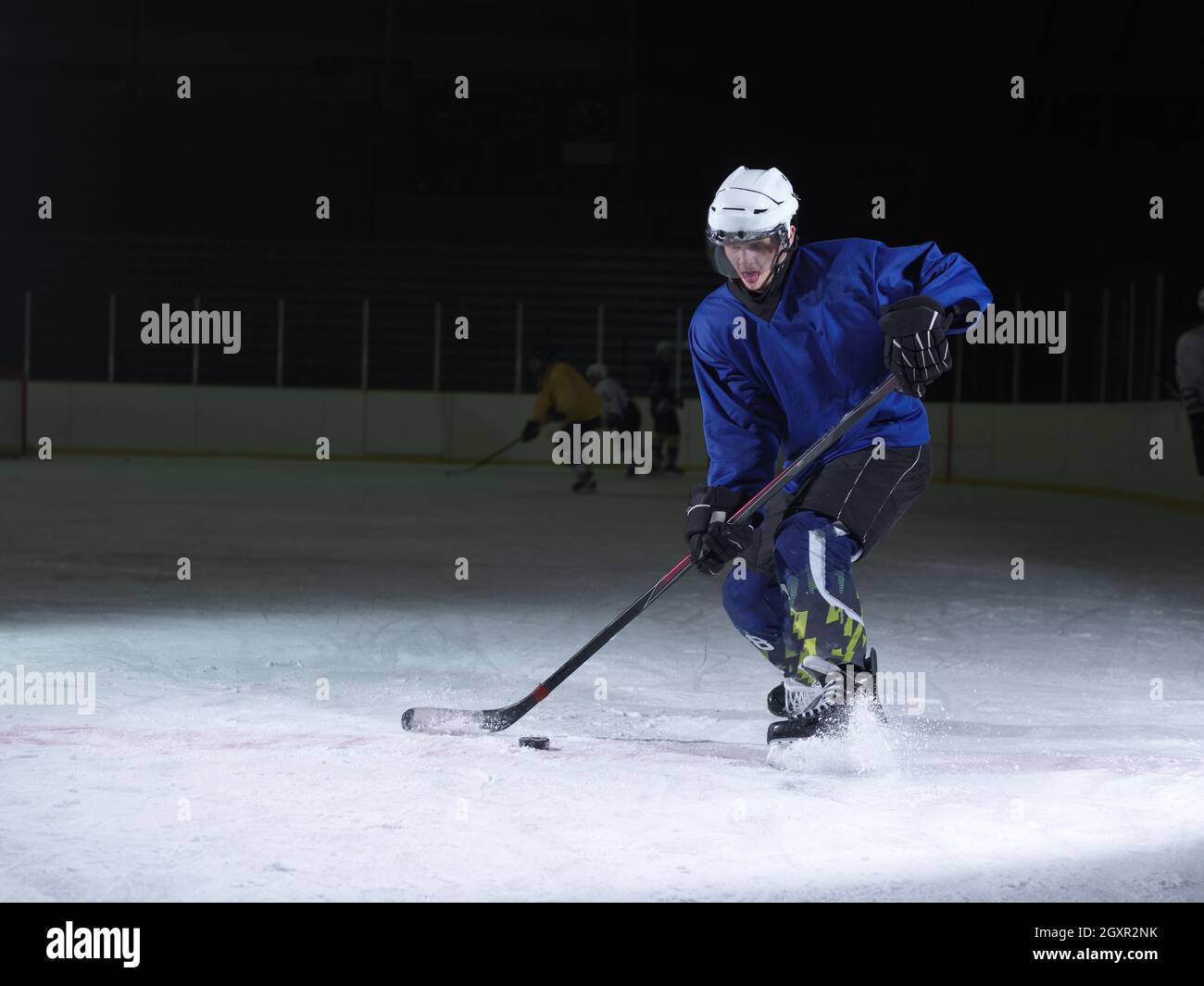ice hockey player in action kicking with stick Stock Photo - Alamy