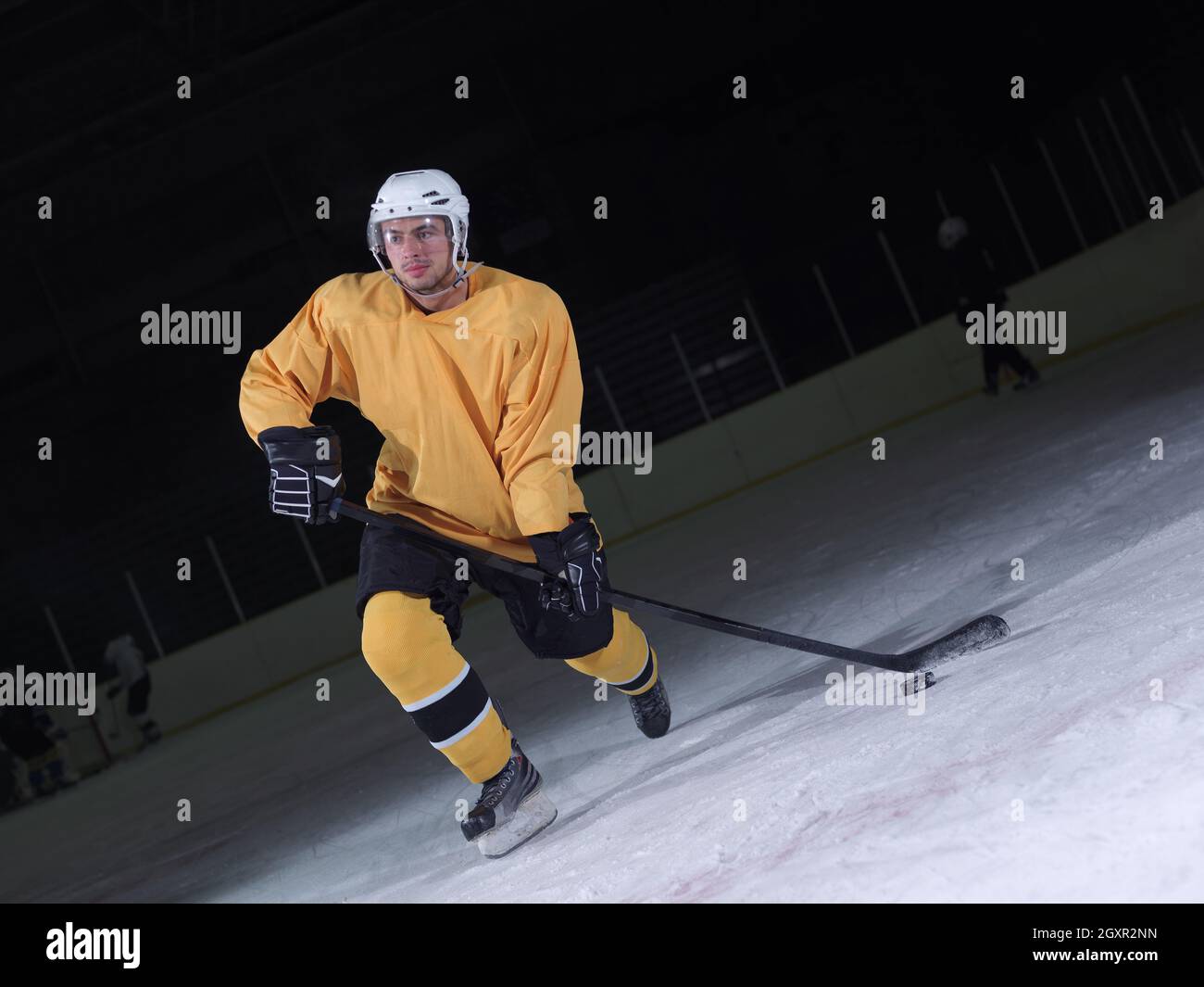 ice hockey player in action kicking with stick Stock Photo - Alamy