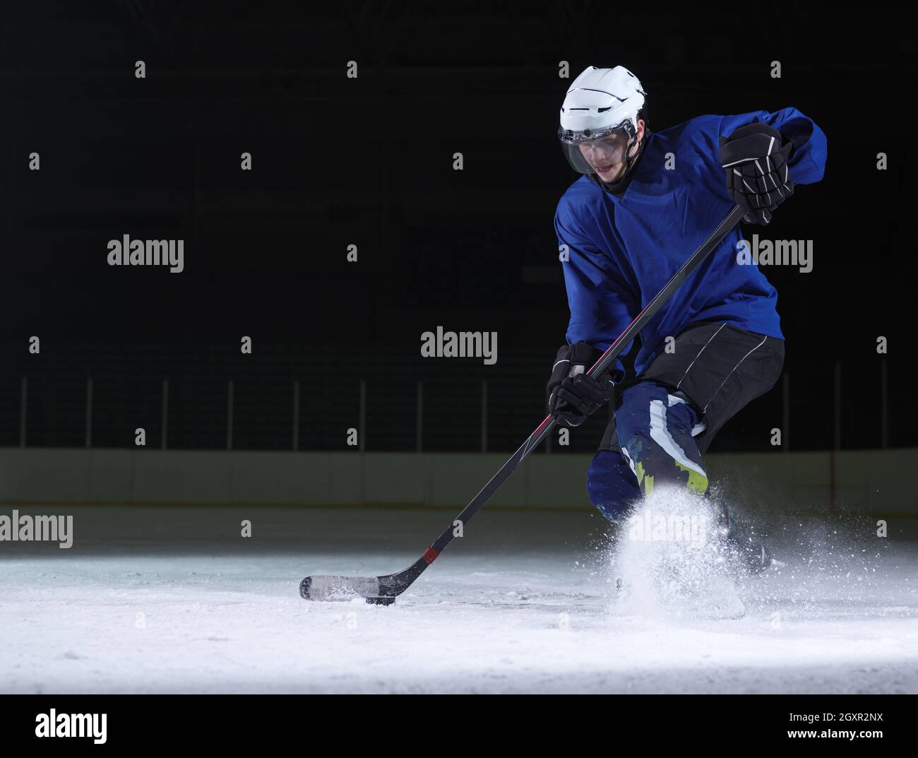 ice hockey player in action kicking with stick Stock Photo - Alamy