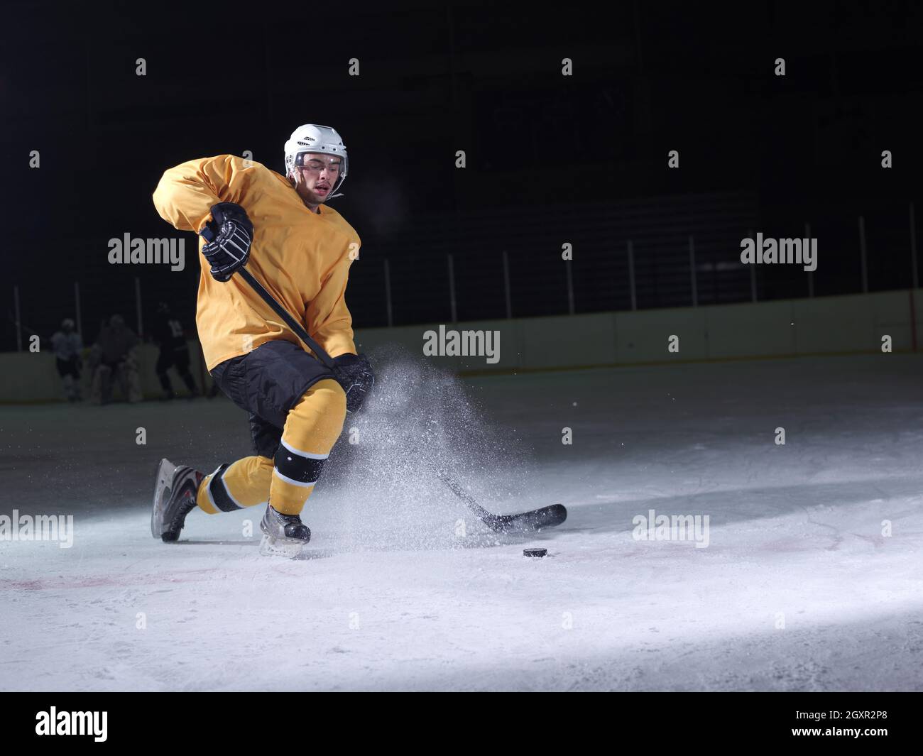 ice hockey player in action kicking with stick Stock Photo - Alamy