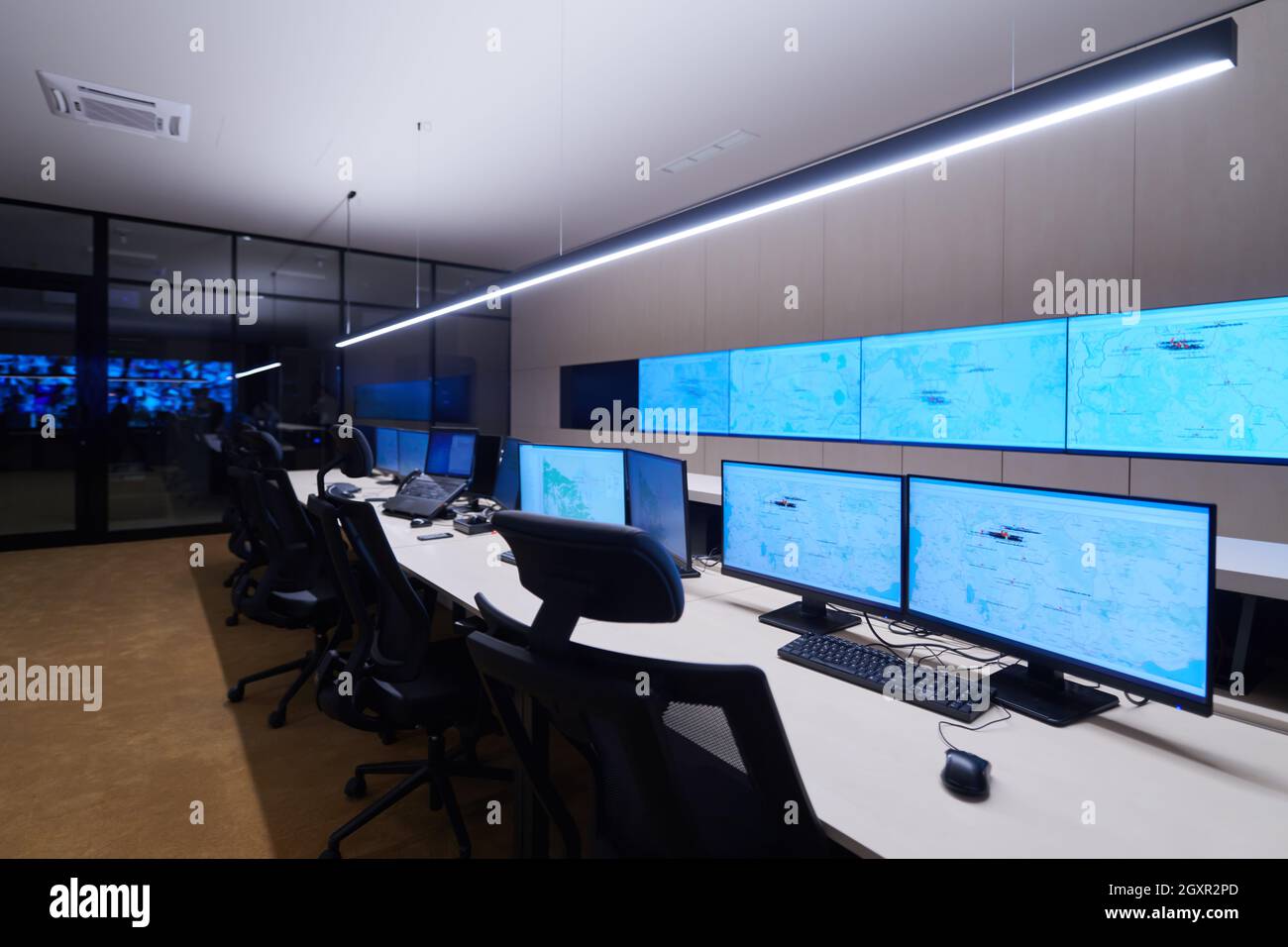 Empty interior of big modern security system control room, workstation ...