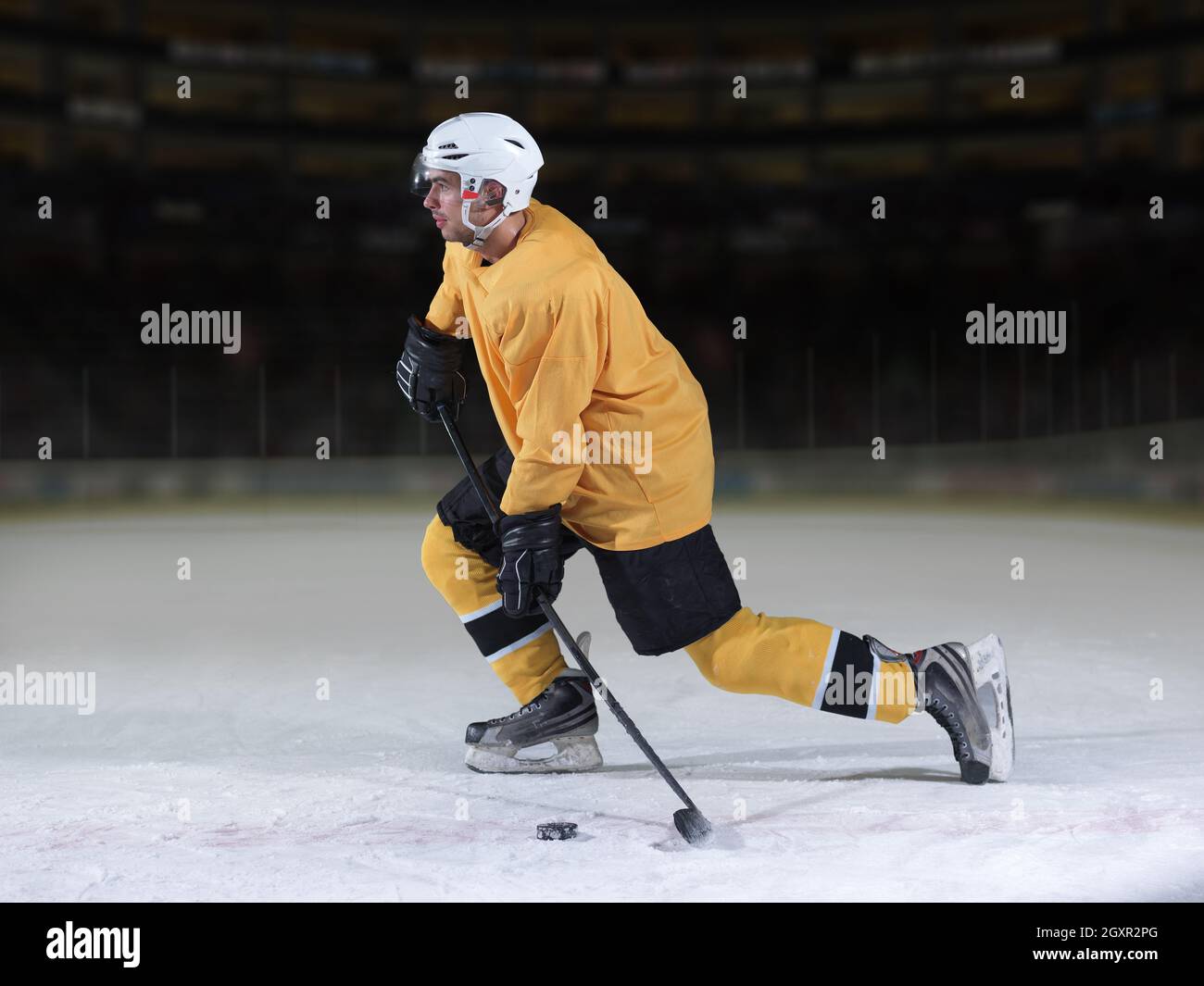 ice hockey player in action kicking with stick Stock Photo - Alamy