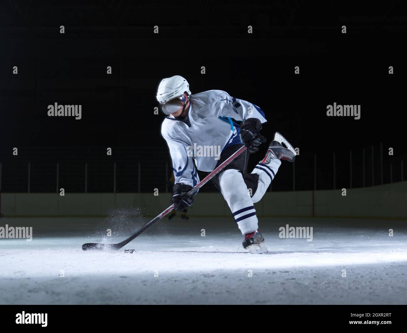 ice hockey player in action kicking with stick Stock Photo - Alamy