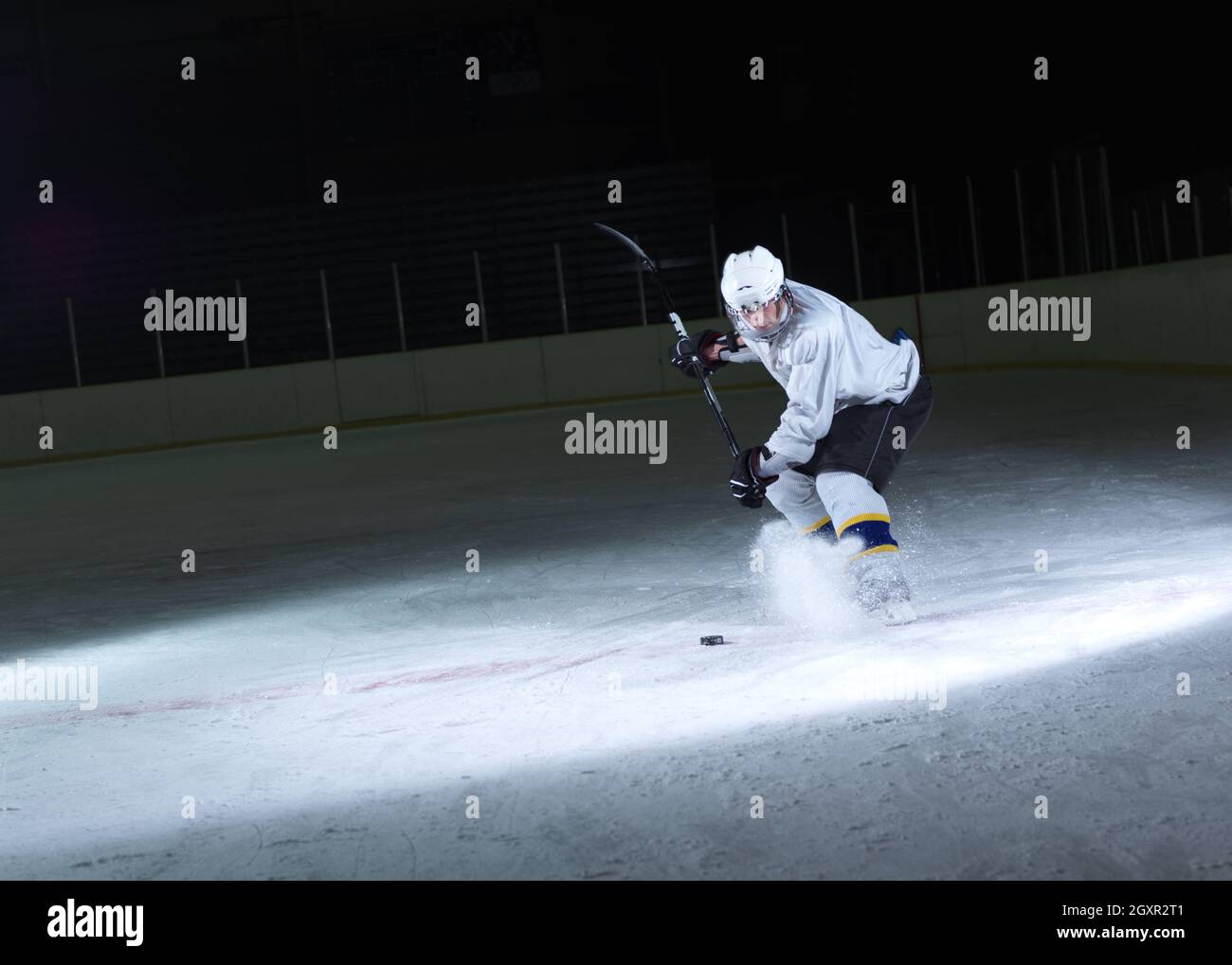 ice hockey player in action kicking with stick Stock Photo - Alamy