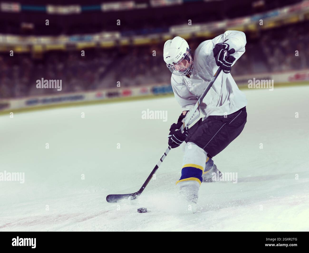 ice hockey player in action kicking with stick Stock Photo - Alamy