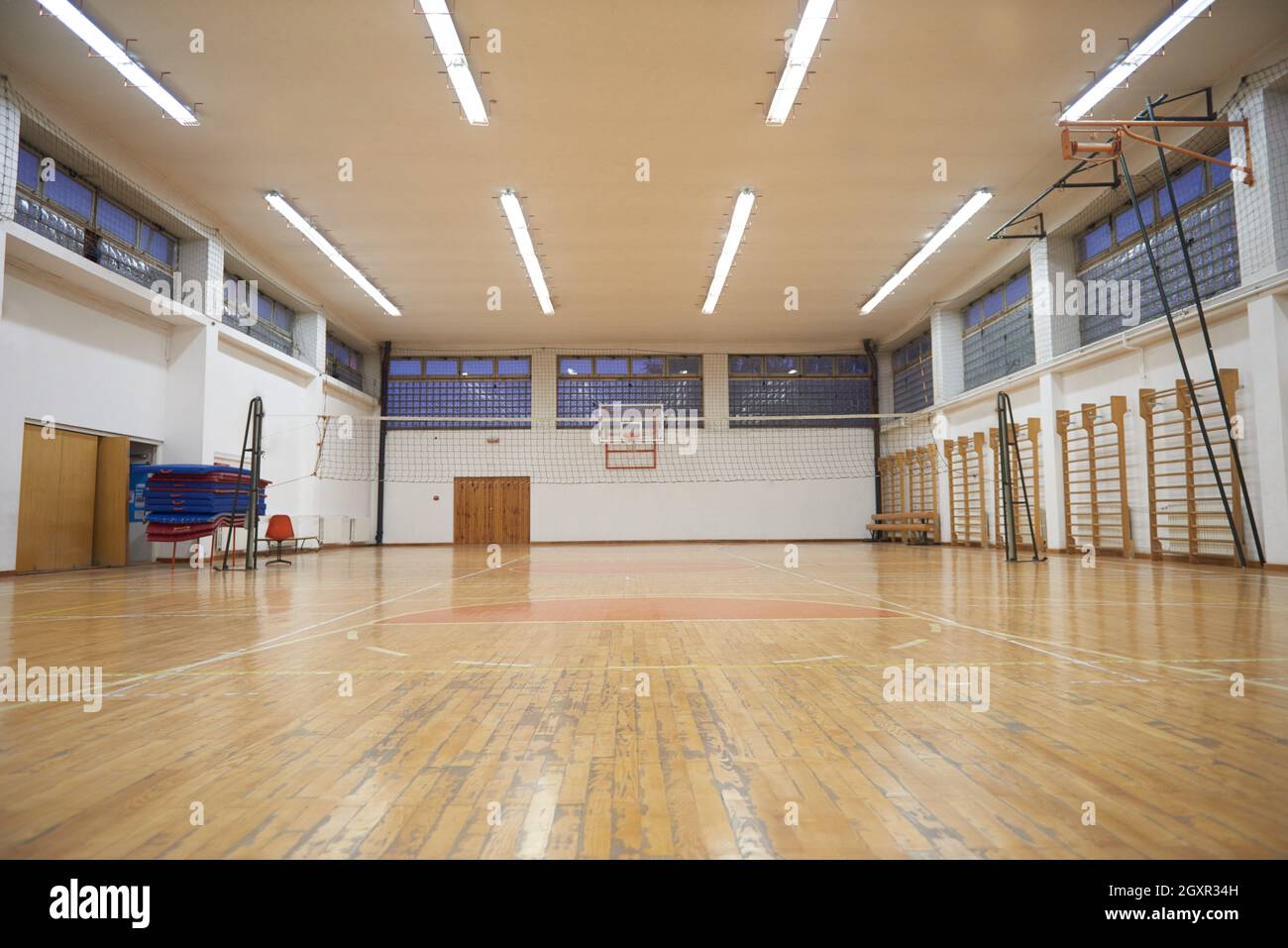 elementary school gym indoor with volleyball net Stock Photo - Alamy