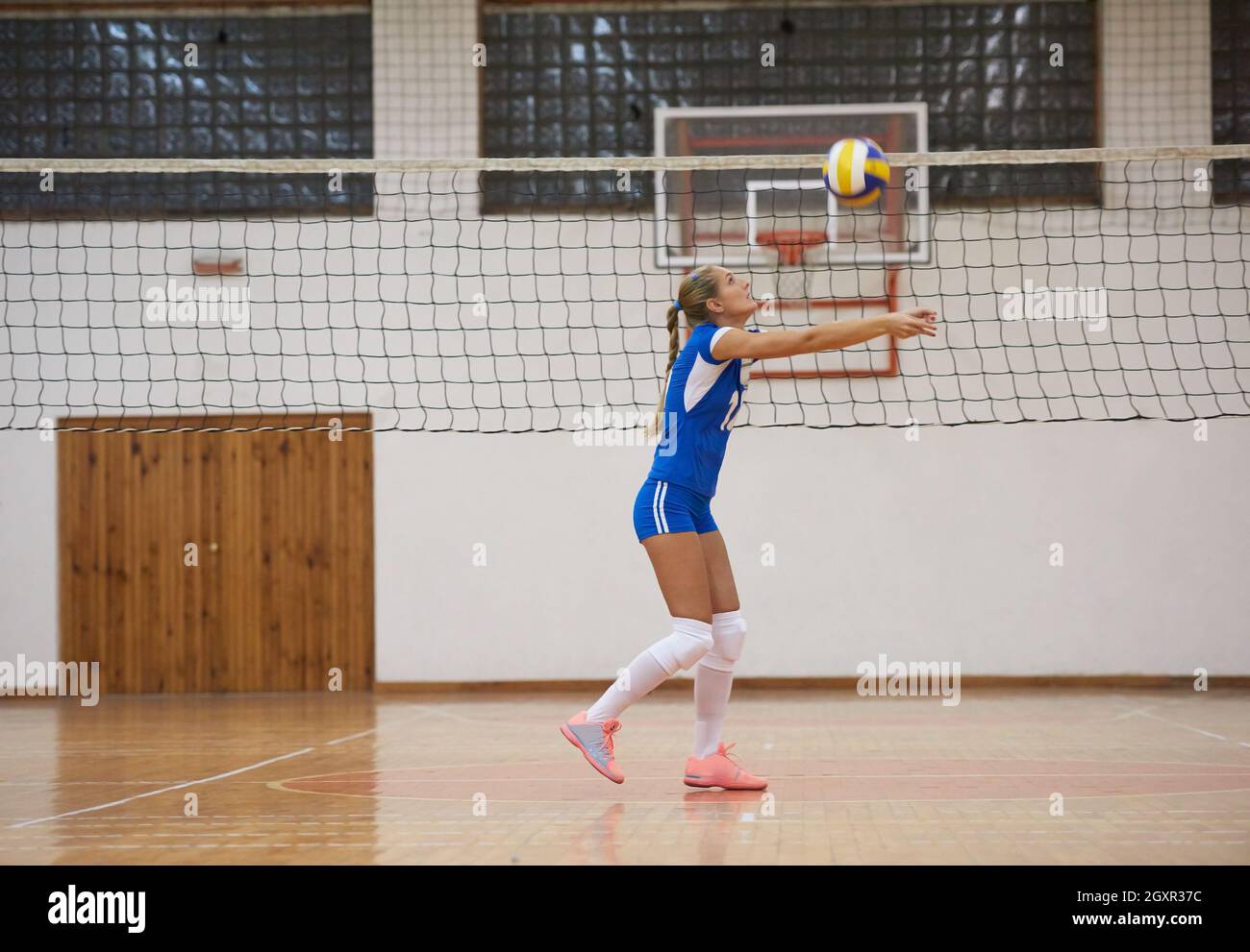 volleyball game sport with group of young beautiful girls indoor in ...