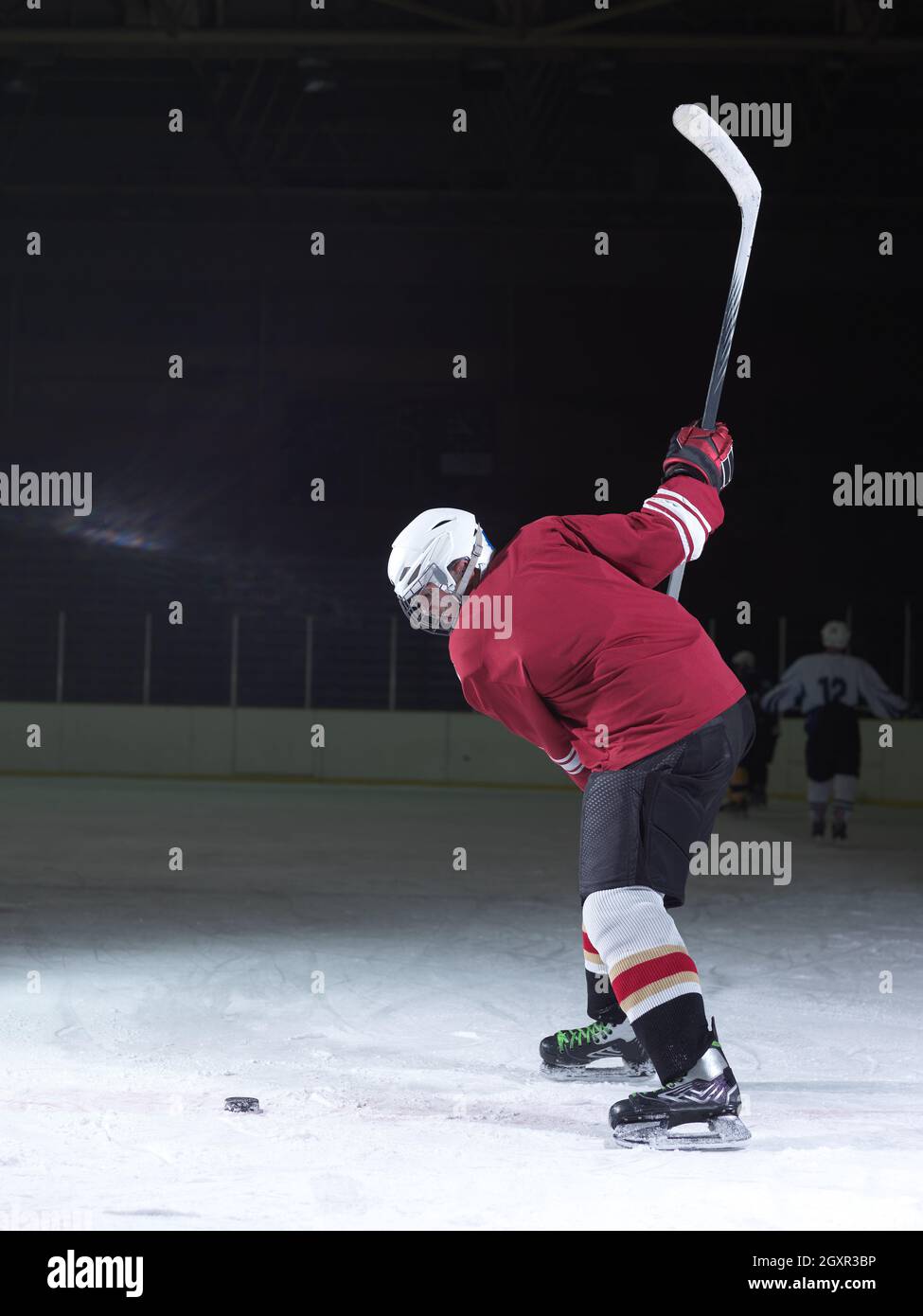 ice hockey player in action kicking with stick Stock Photo - Alamy