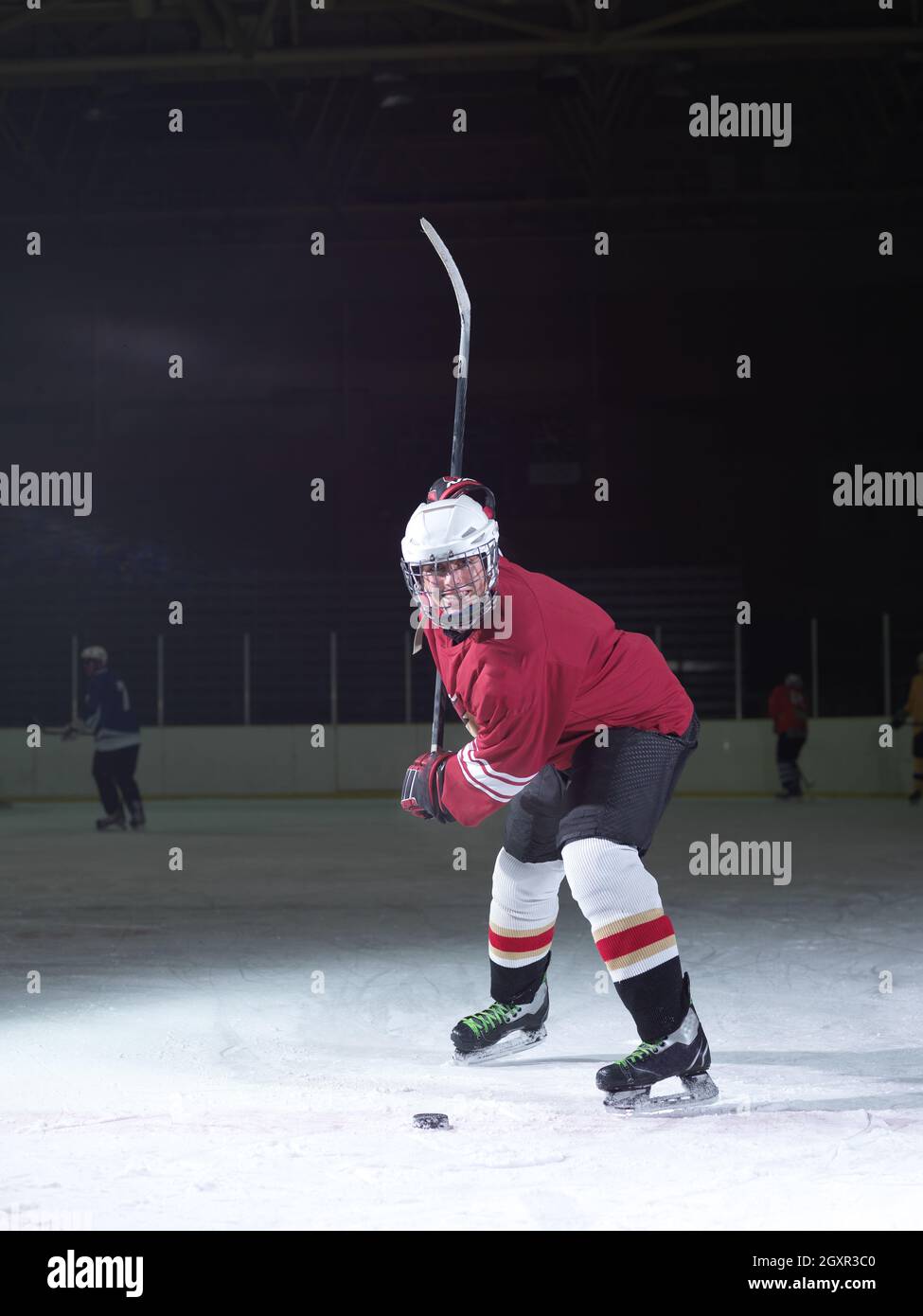 ice hockey player in action kicking with stick Stock Photo - Alamy
