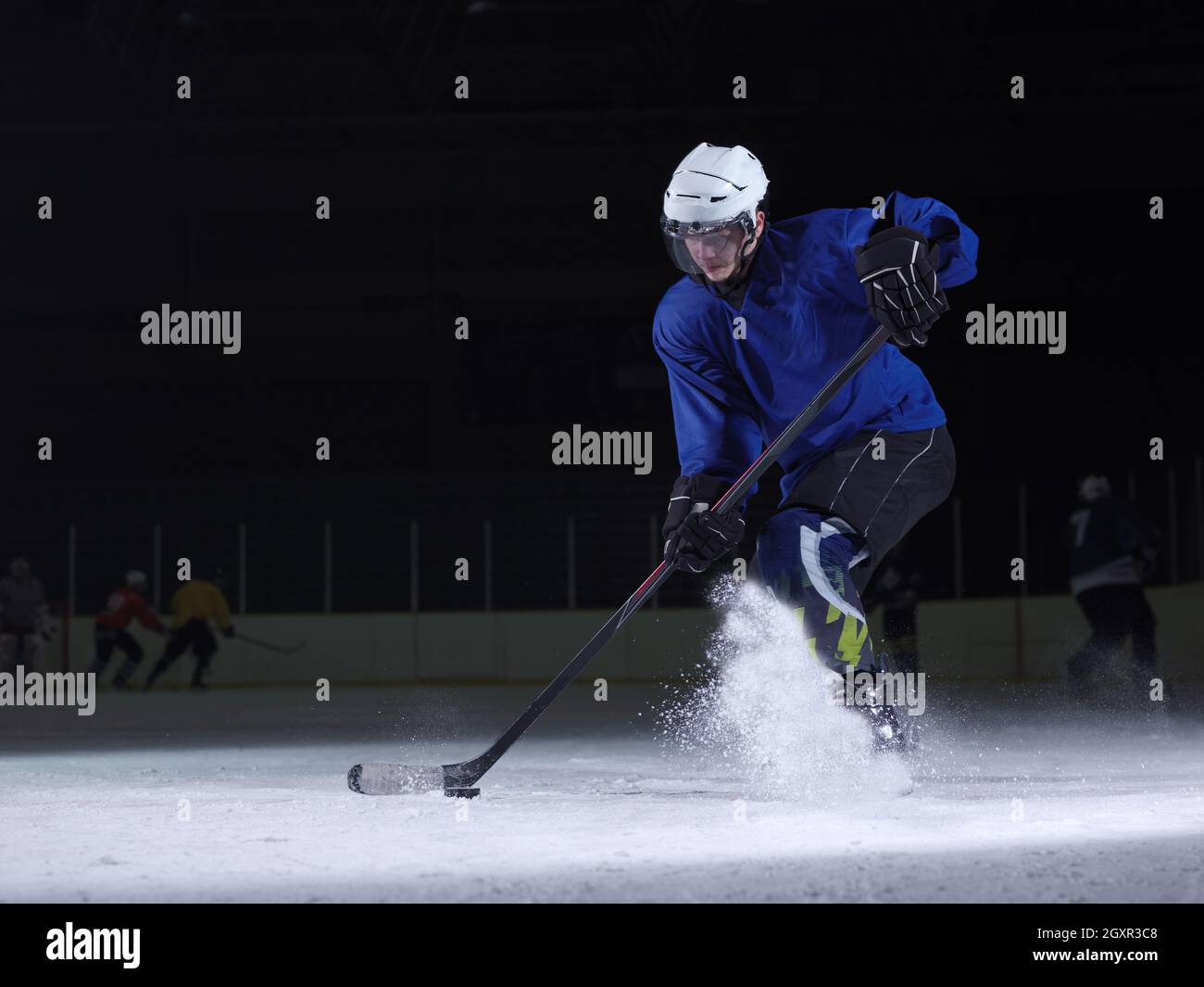 ice hockey player in action kicking with stick Stock Photo - Alamy