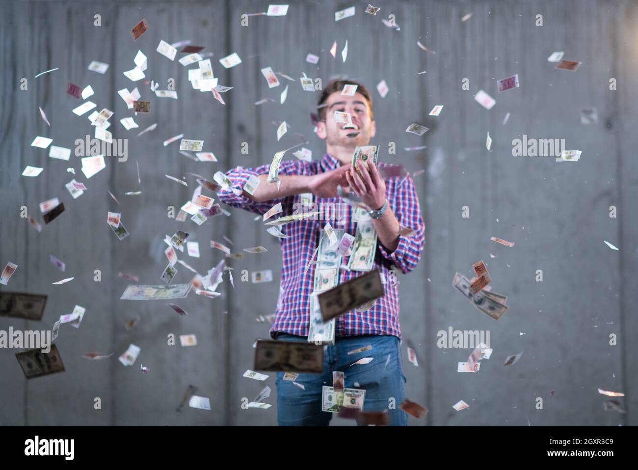 business, people and finances concept Happy young businessman throwing ...