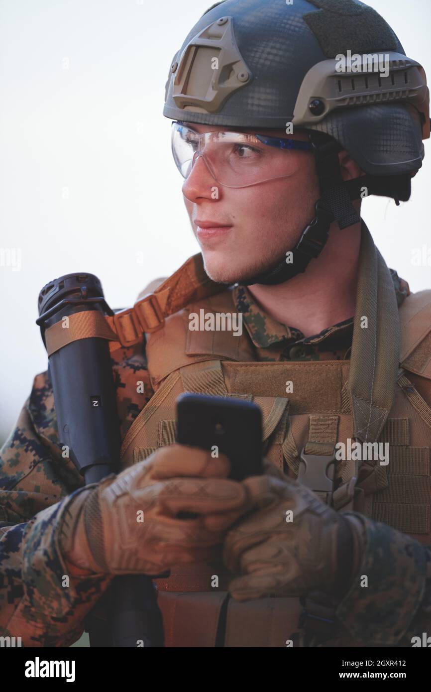 soldier using smart phone to contact family or girlfriend communication ...
