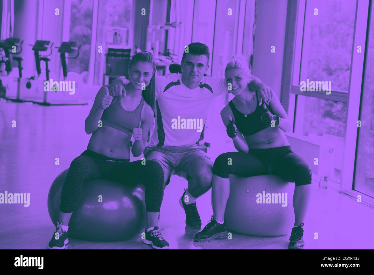 group portrait of healthy and fit young people in fitness gym duo tone ...