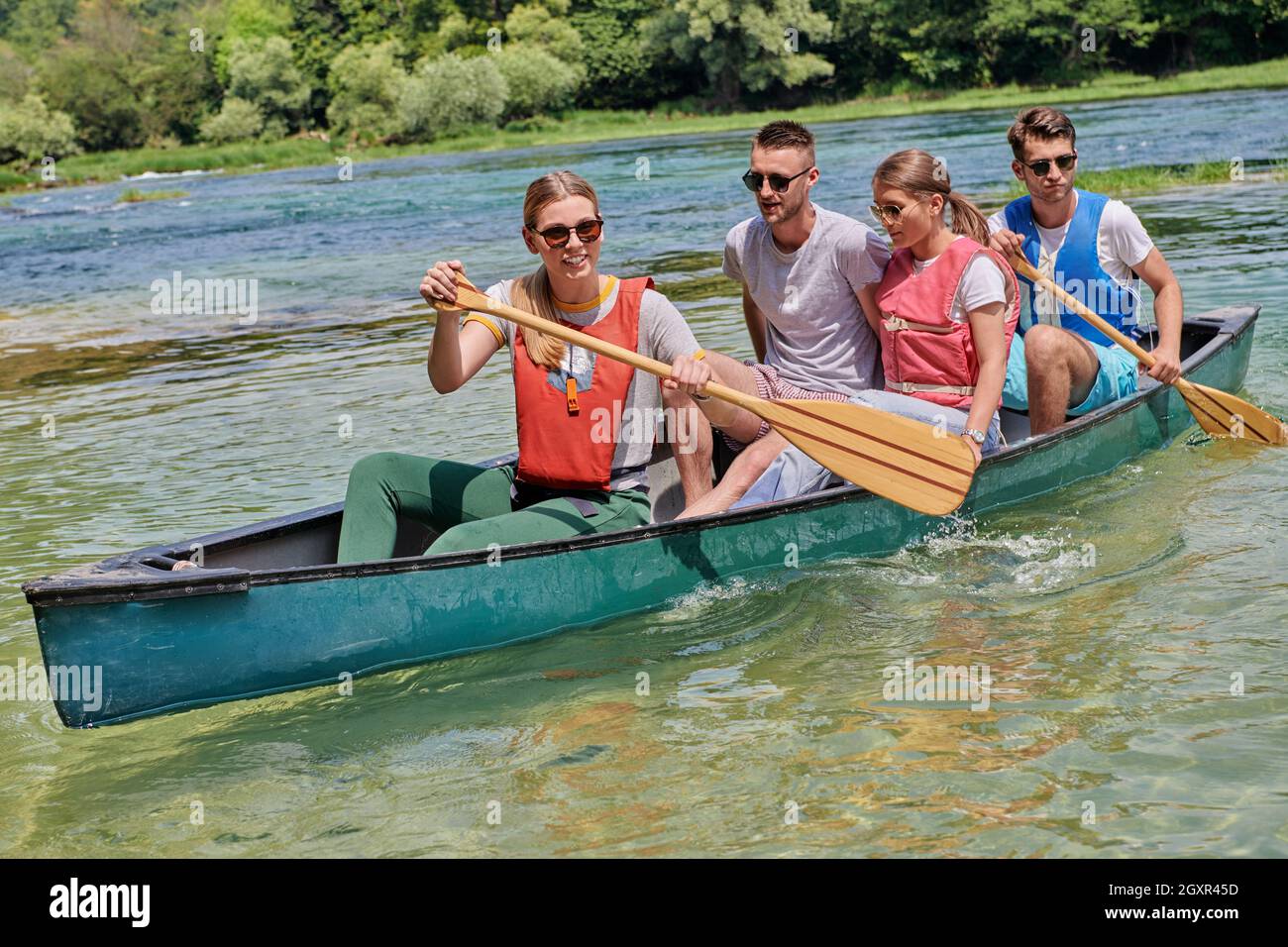 Group adventurous explorer friends are canoeing in a wild river ...