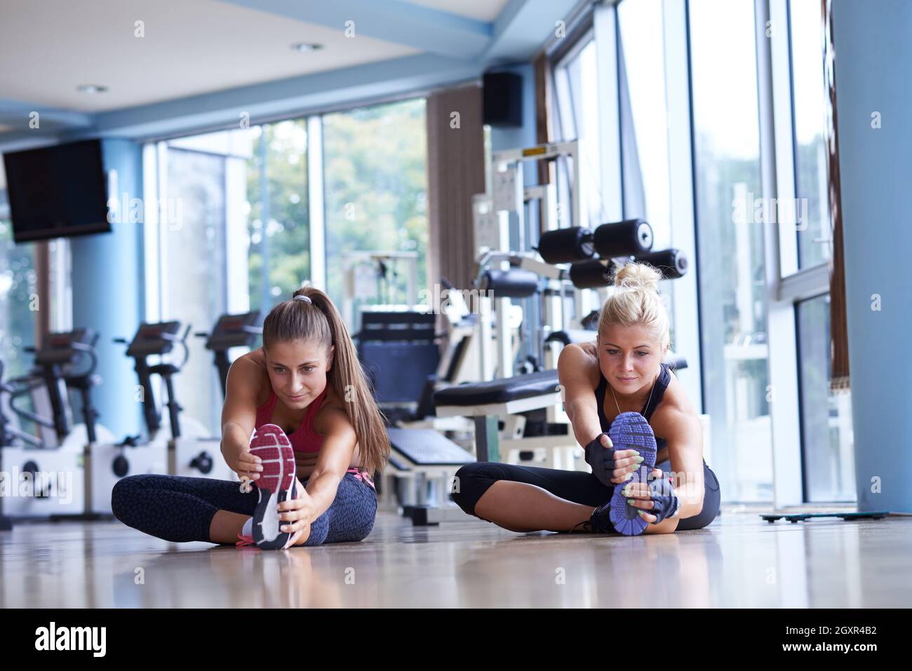 woman exercise and working out with fitness personal trainer in gym ...