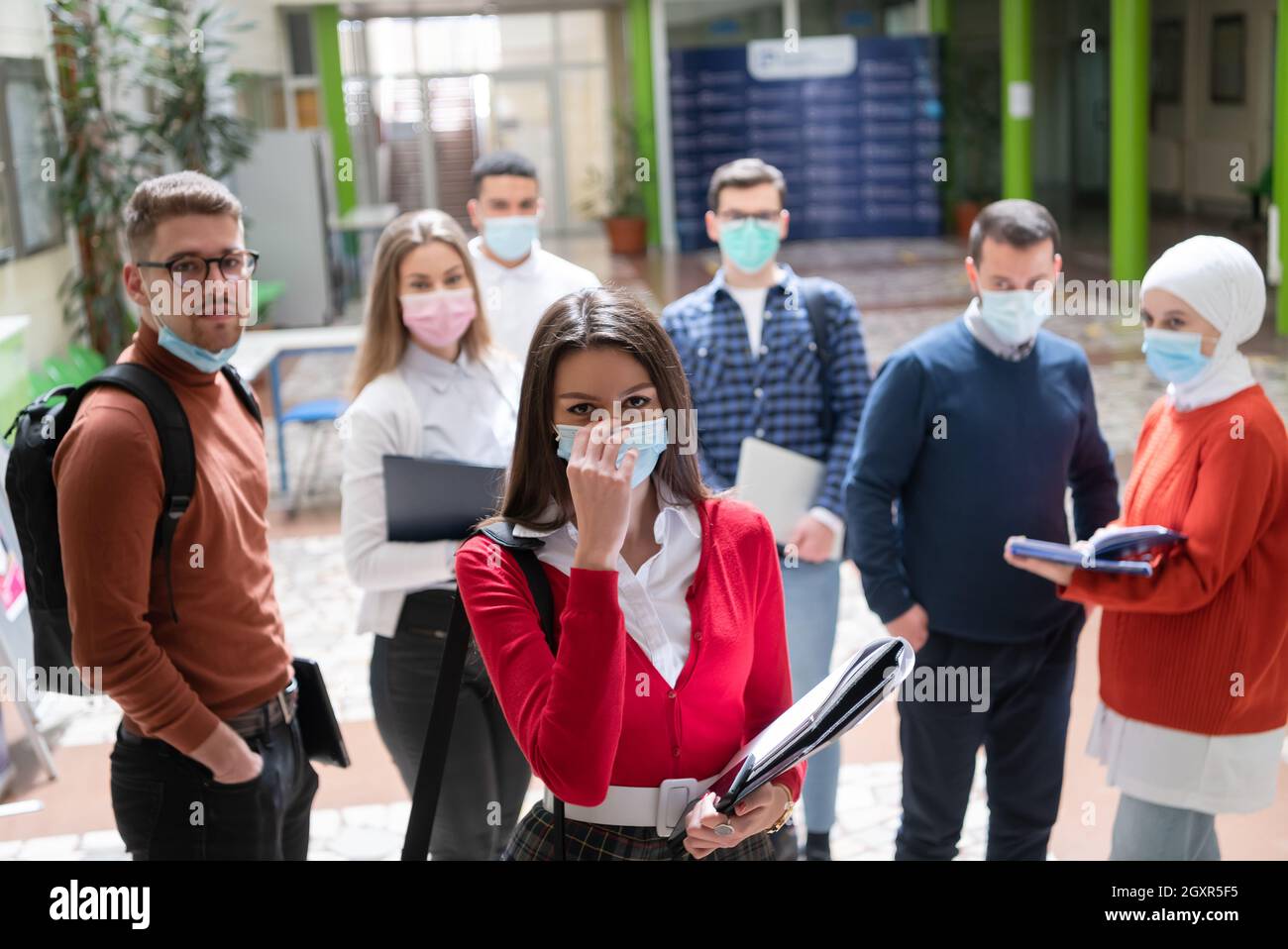 Portrait of multiethnic students group at university wearing protective ...