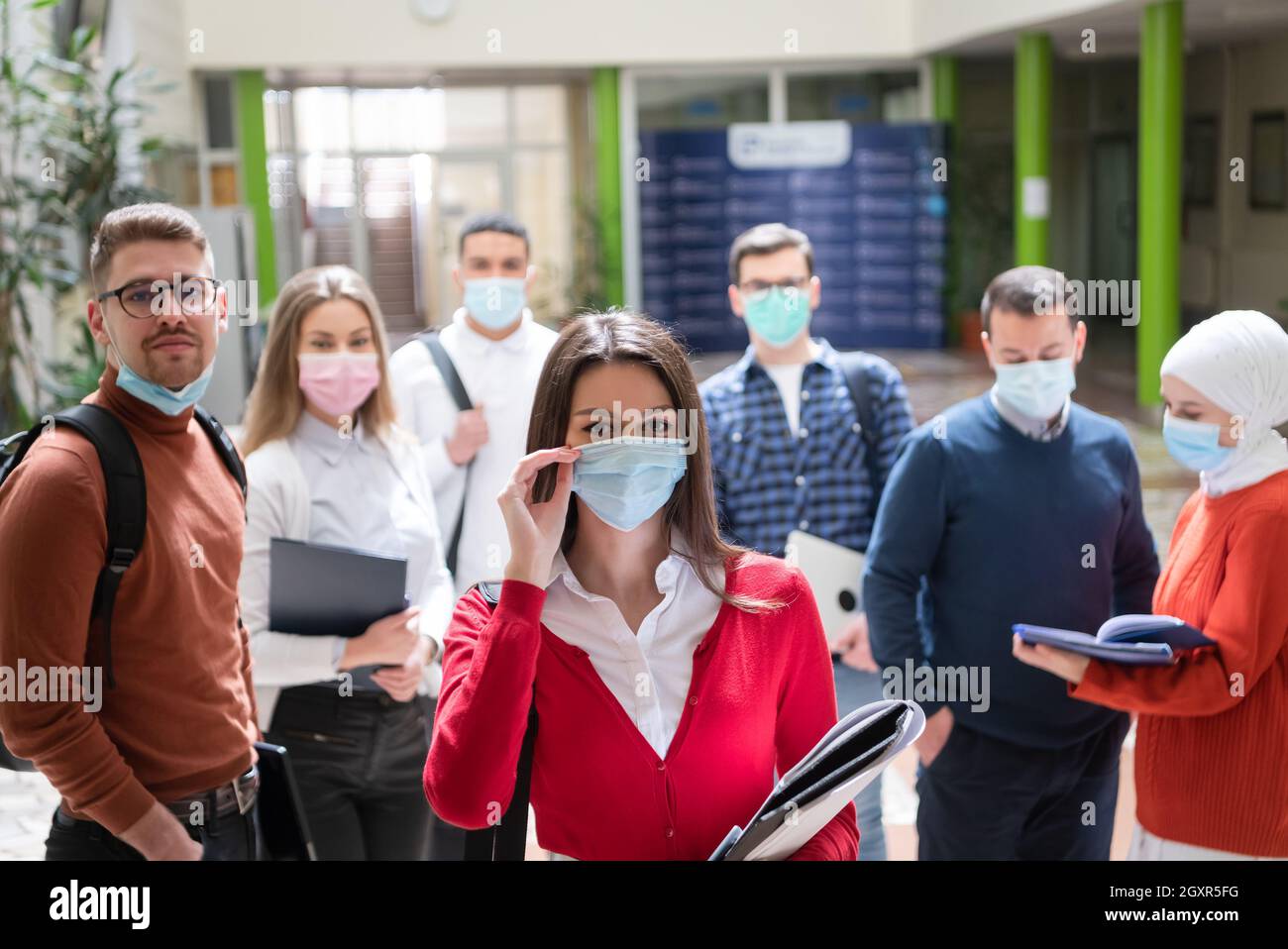 Portrait of multiethnic students group at university wearing protective ...