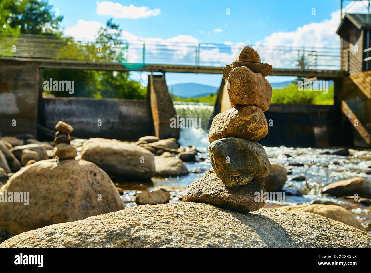 Stack of Cairn stones with background of dam river and walkway Stock ...