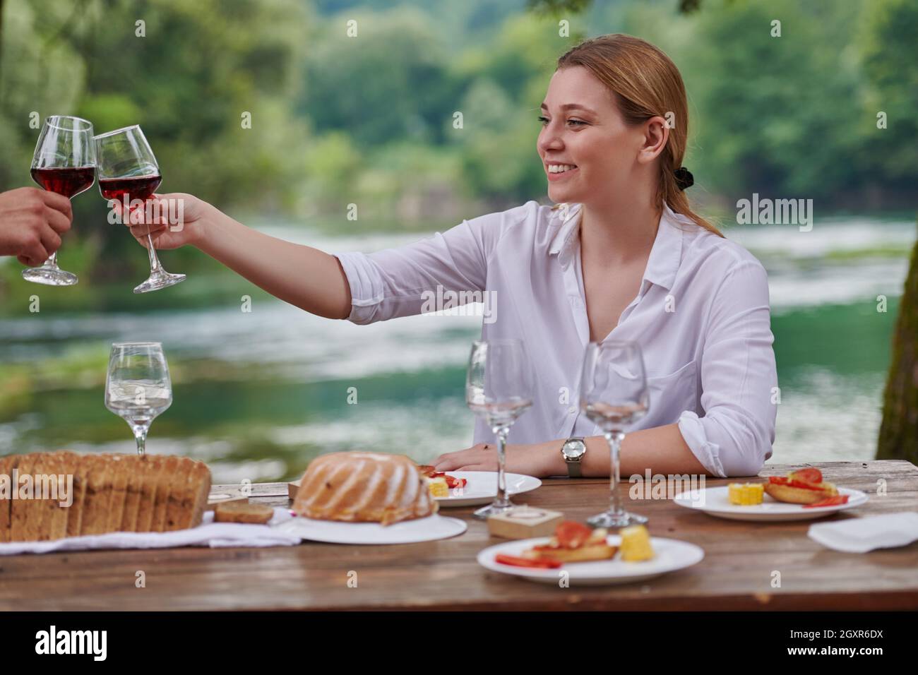 two young happy girlfriends having picnic french dinner party outdoor ...