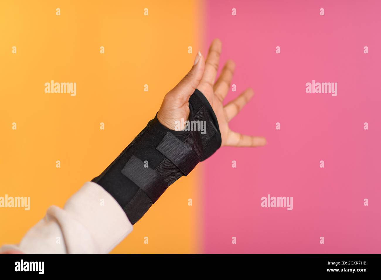 hand injury. a female injured hand on a yellow background Stock Photo ...