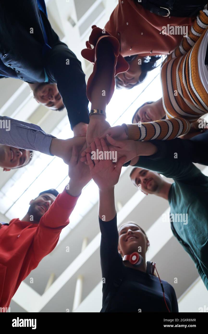 Group of young students in electronics classroom celebrating ...