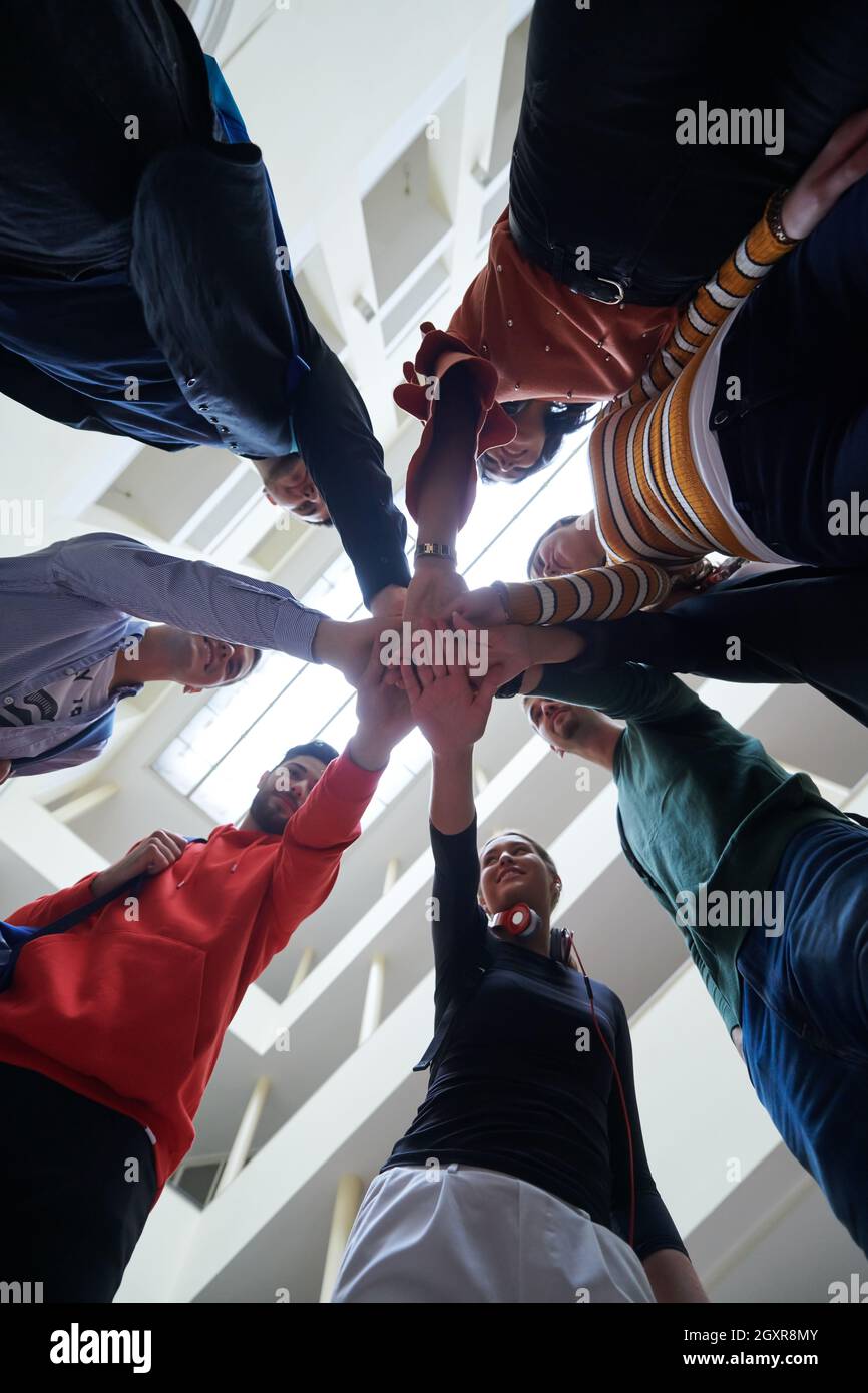 Group of young students in electronics classroom celebrating ...