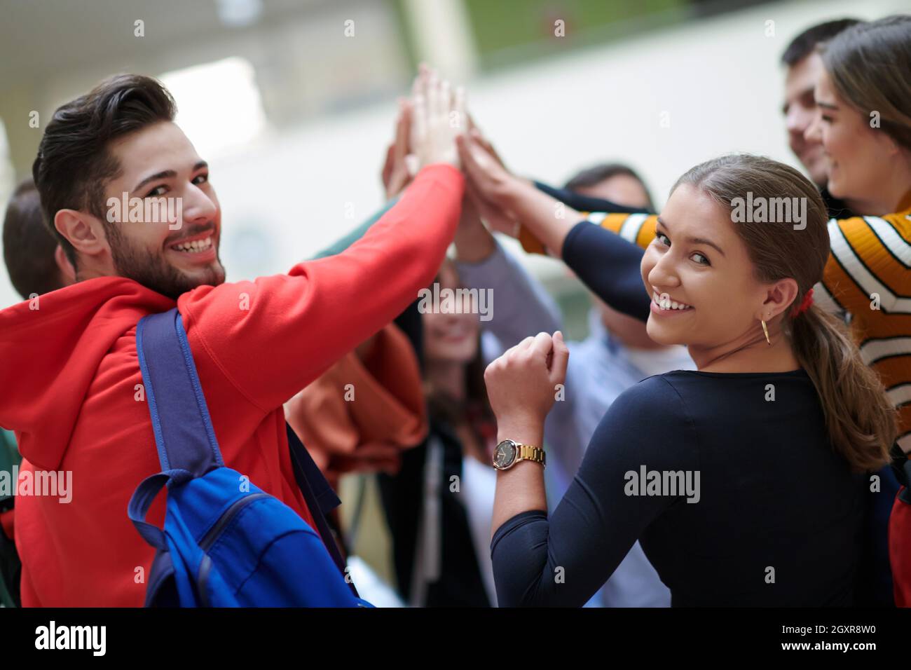Happy Students Putting their Hands Together in the Air Inside the ...