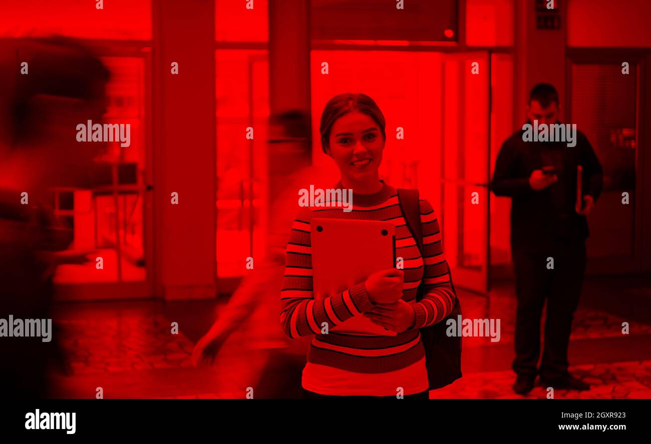 portrait of a happy young student getting ready for class while waiting ...