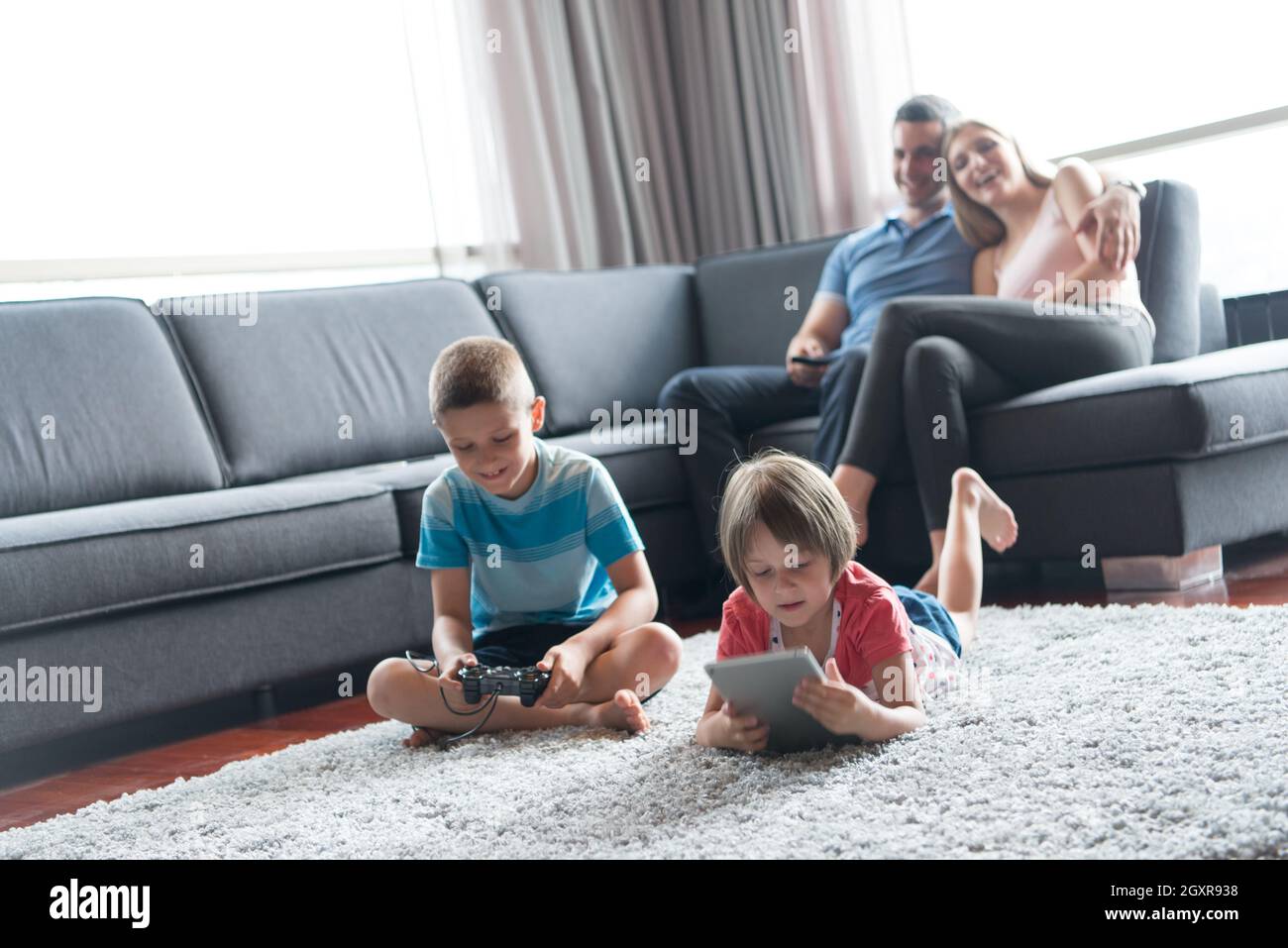 Happy Young Family Playing Together at home Stock Photo - Alamy